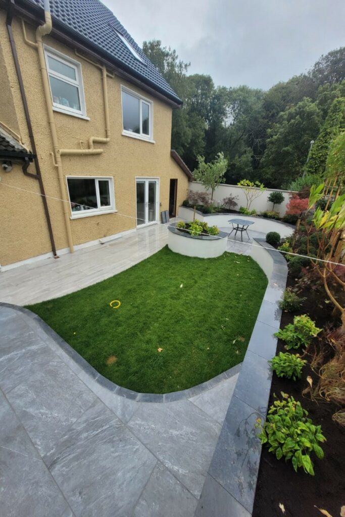 Round Porcelain Tiled Patio with Retaining Walls and Roll-on-Turf in ...